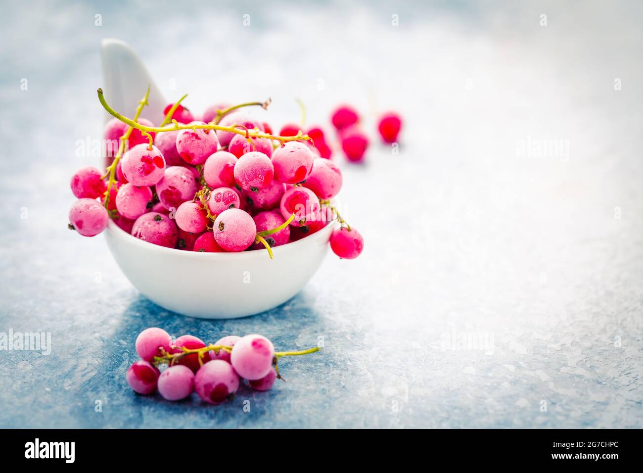 Frozen red currant in bowl on kitchen table Stock Photo - Alamy