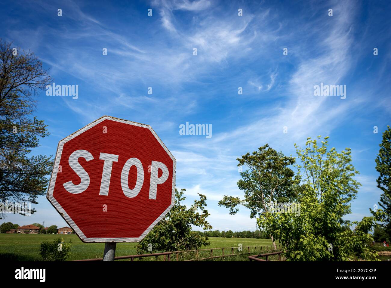 Close-up of a Stop Road Sign on blue sky with clouds and copy space ...