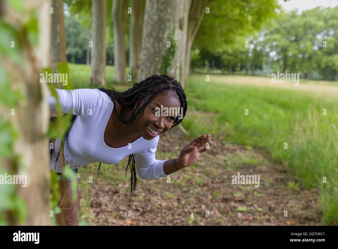 Girl Hiding Behind Tree