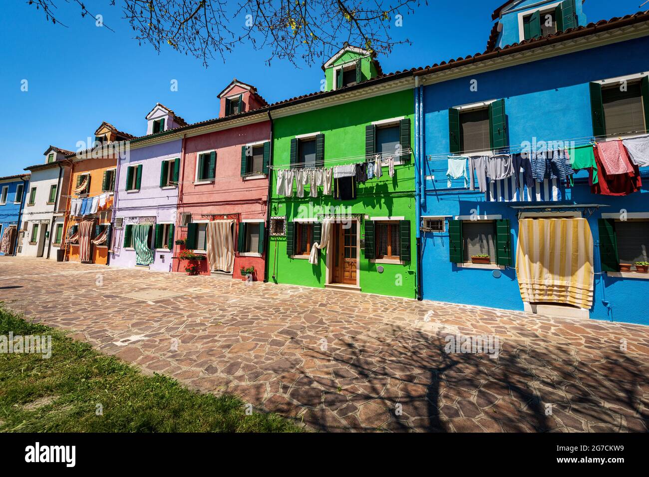 Burano island with beautiful multi colored houses with clothes hanging ...
