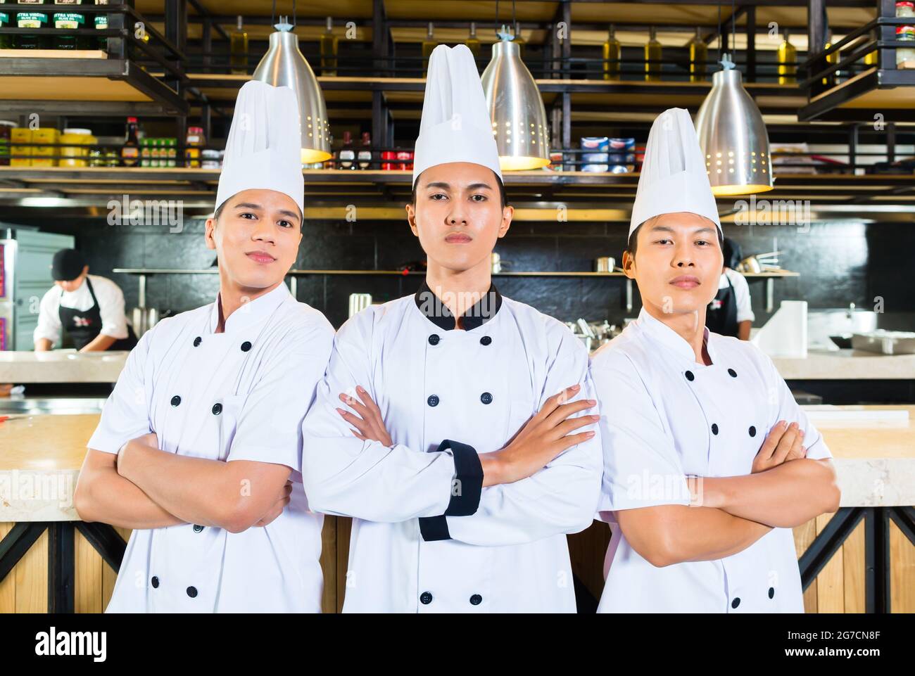 Young chefs standing with arms crossed Stock Photo - Alamy
