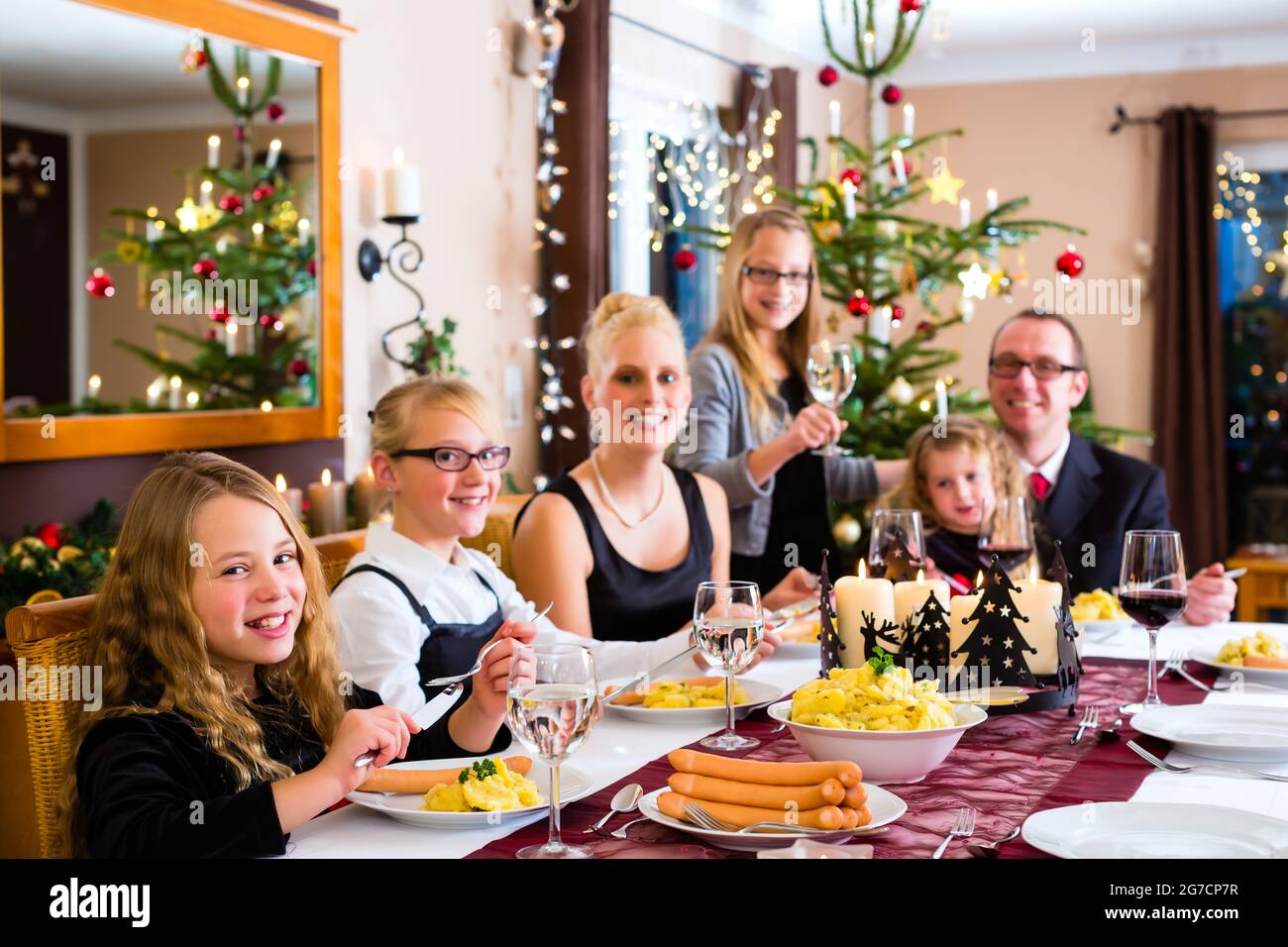 Family of Mother, father, children celebrating Christmas eve with ...
