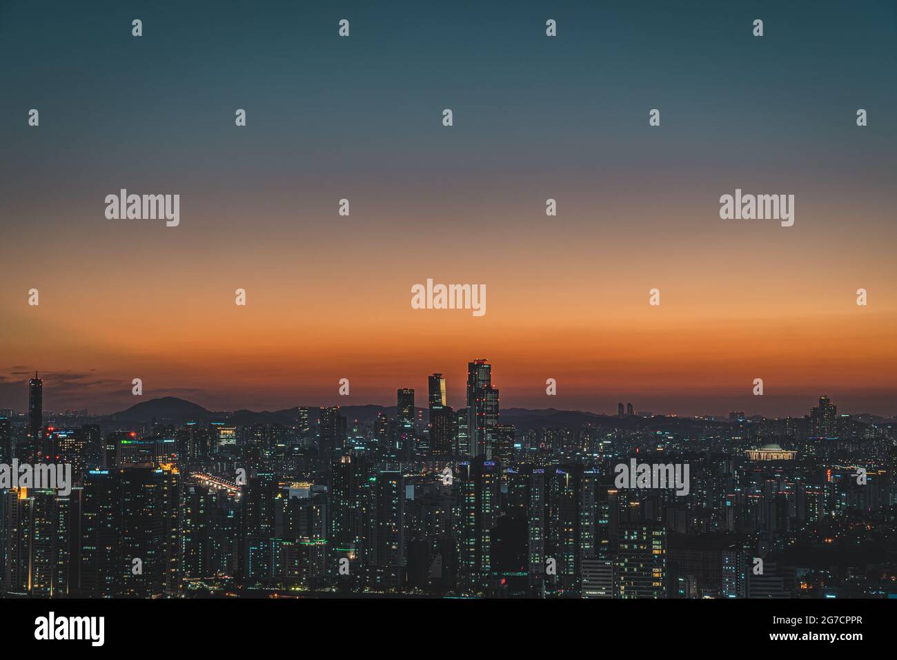 Beautiful shot of orange sunset over the illuminated city Stock Photo ...