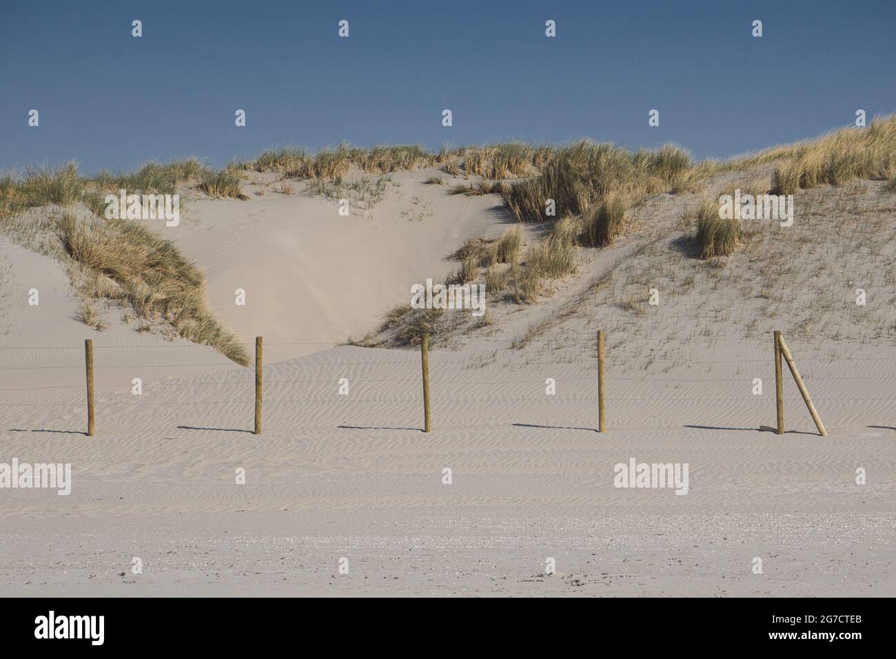 Photo of wooden sticks connected by ropes in the form of a fence in the ...