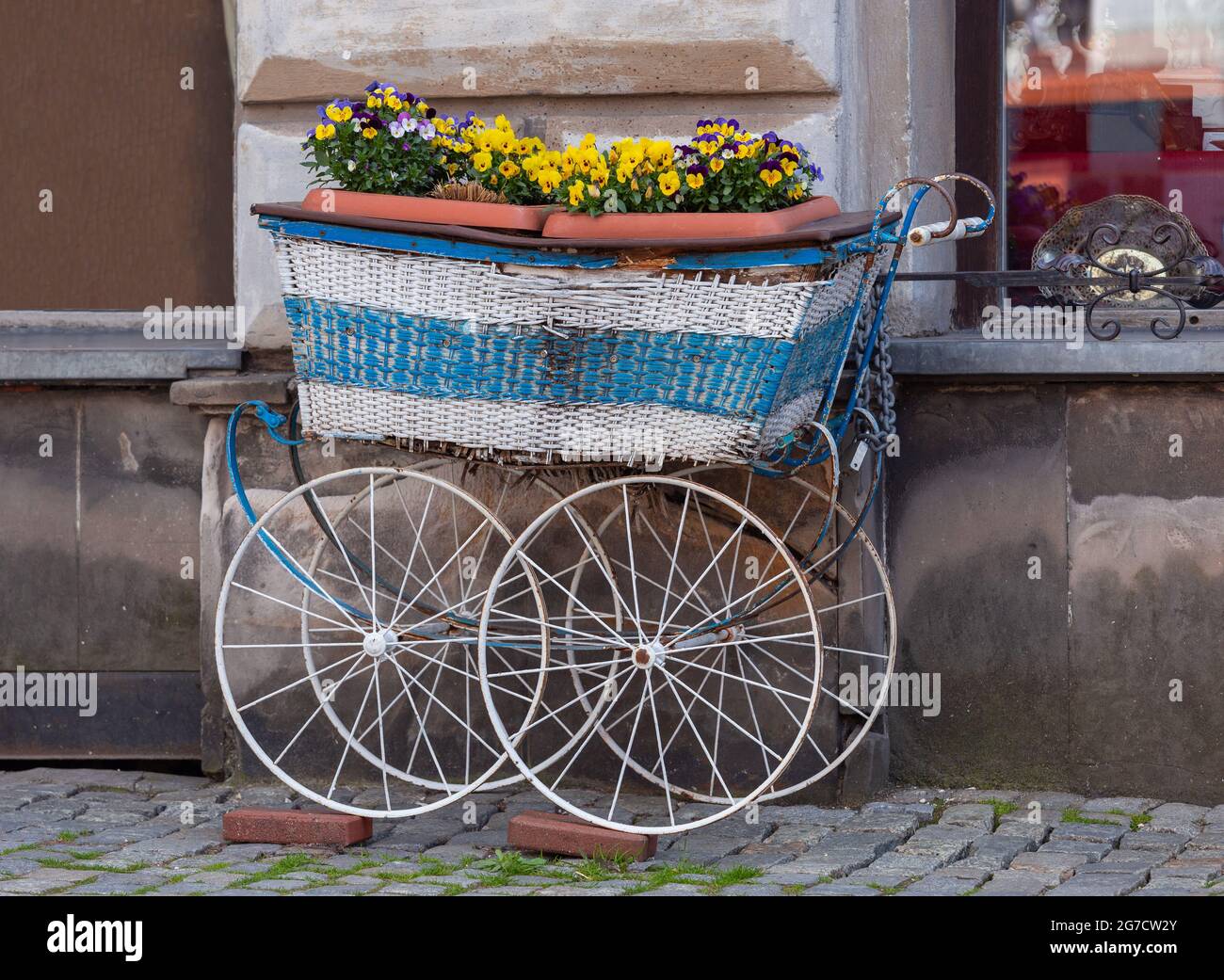 Flowerbed stroller with flowers in the market square in the spring ...