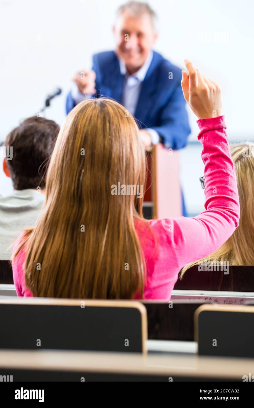 College professor giving lecture for students standing at desk Stock ...