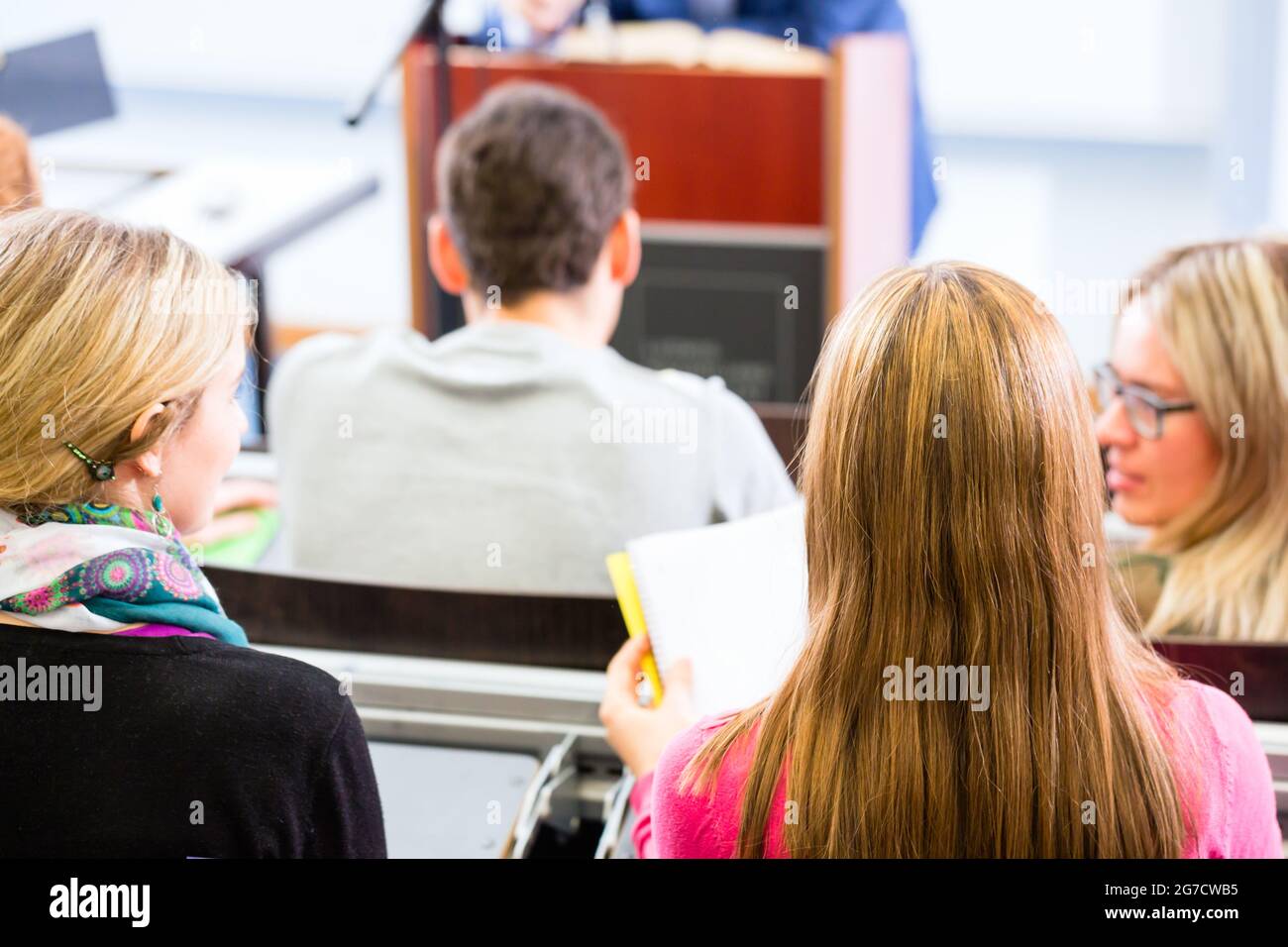College professor giving lecture for students standing at desk Stock ...