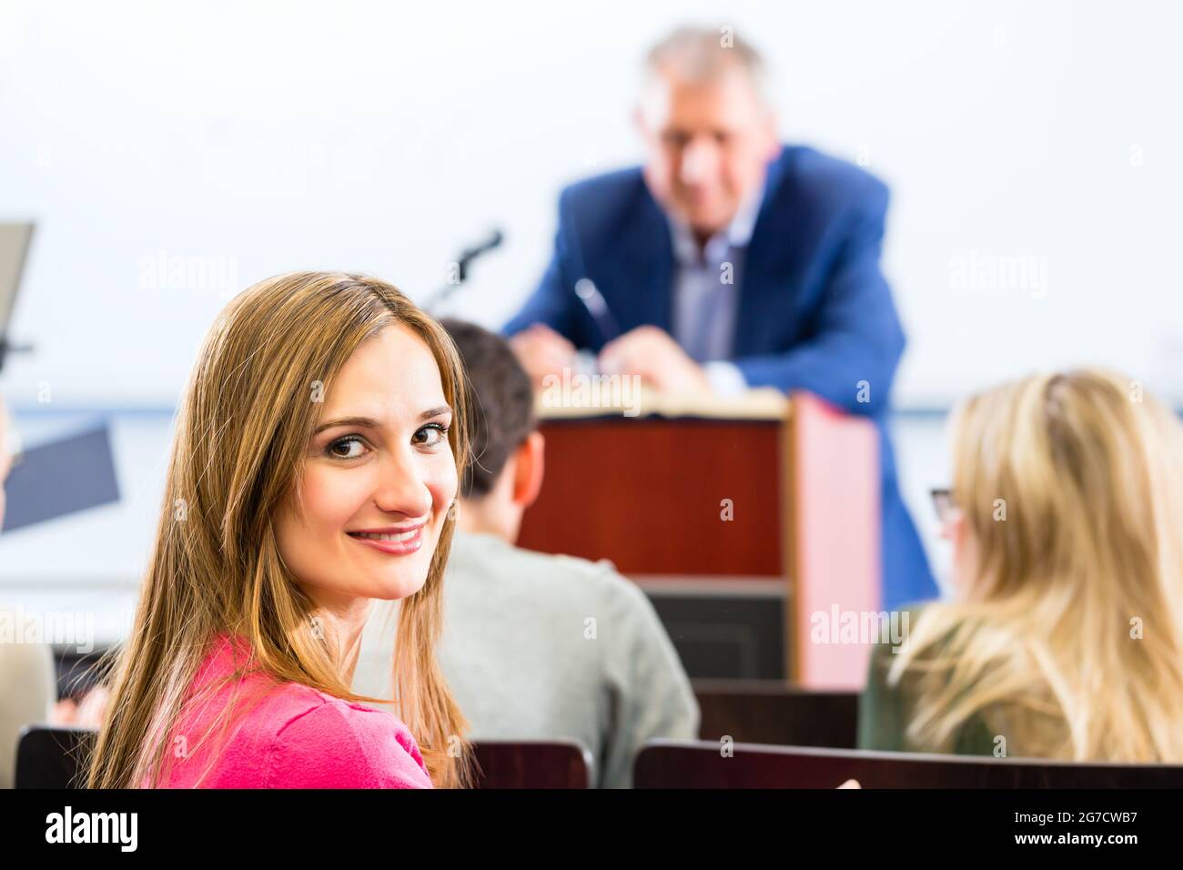 College professor giving lecture for students standing at desk Stock ...