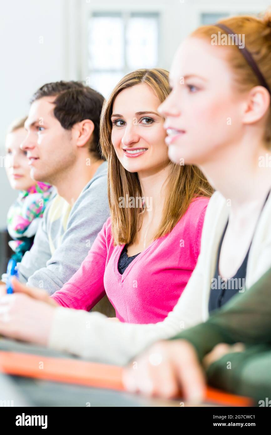 College students making lesson notes in university auditorium Stock ...