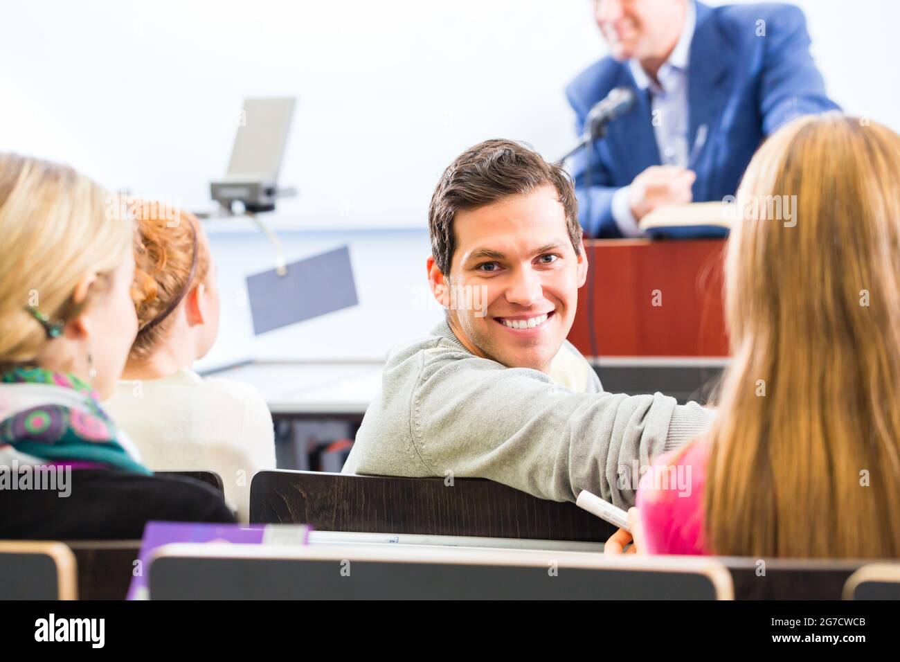 College professor giving lecture for students standing at desk Stock ...