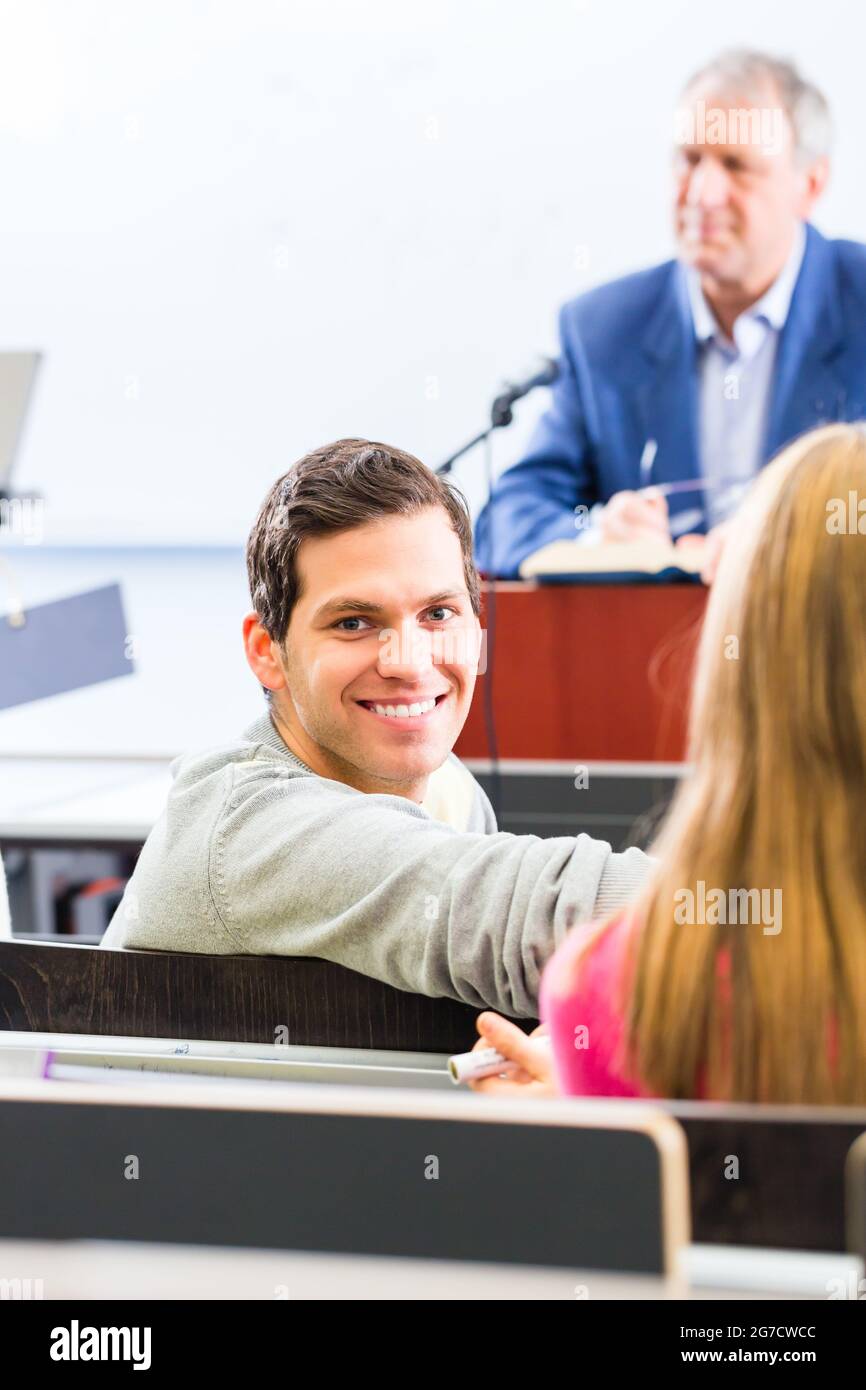 College professor giving lecture for students standing at desk Stock ...