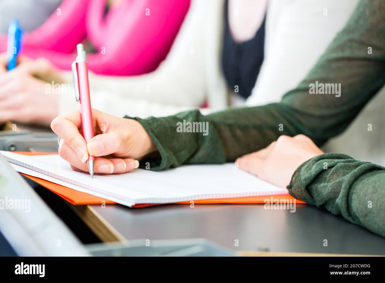 College students making lesson notes in university auditorium Stock ...