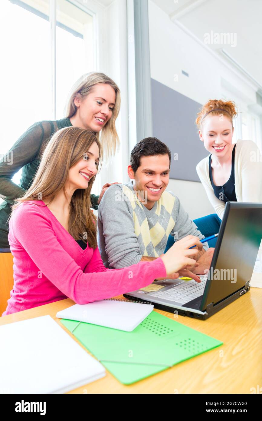 University college students using laptop for project team work learning ...