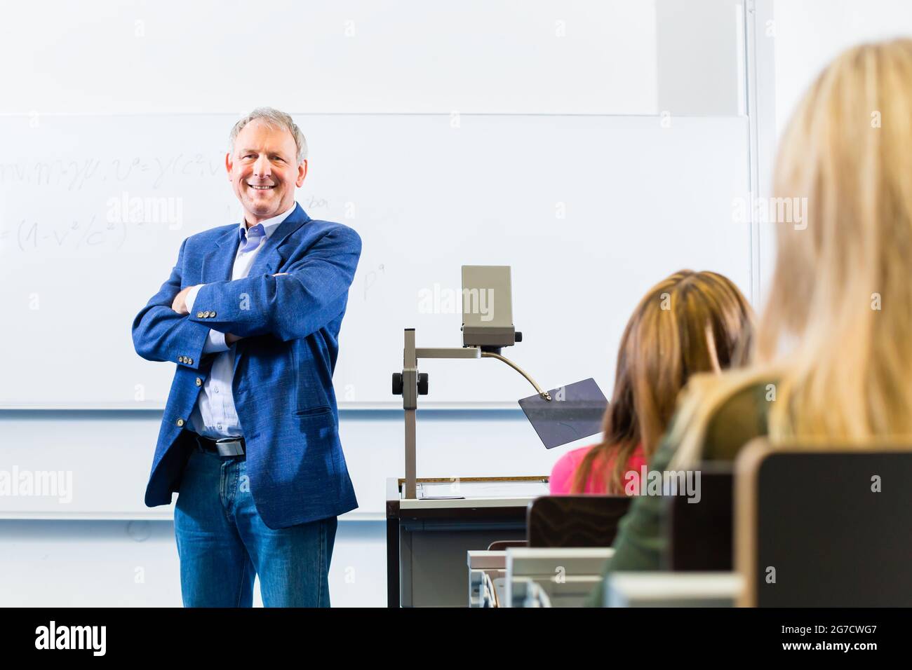 College professor giving lecture in college standing at desk Stock ...
