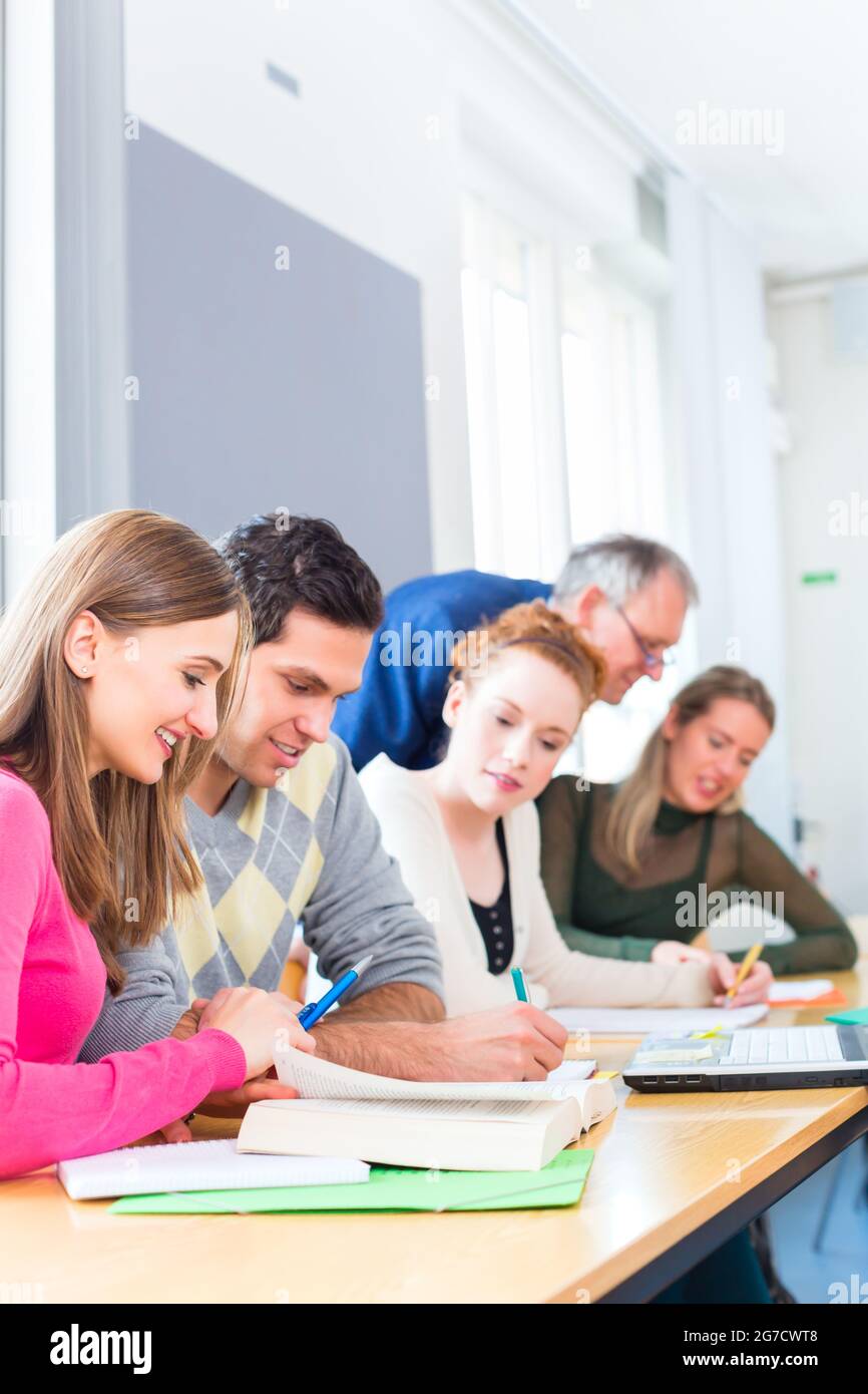 University college students with professor learning in seminar Stock ...