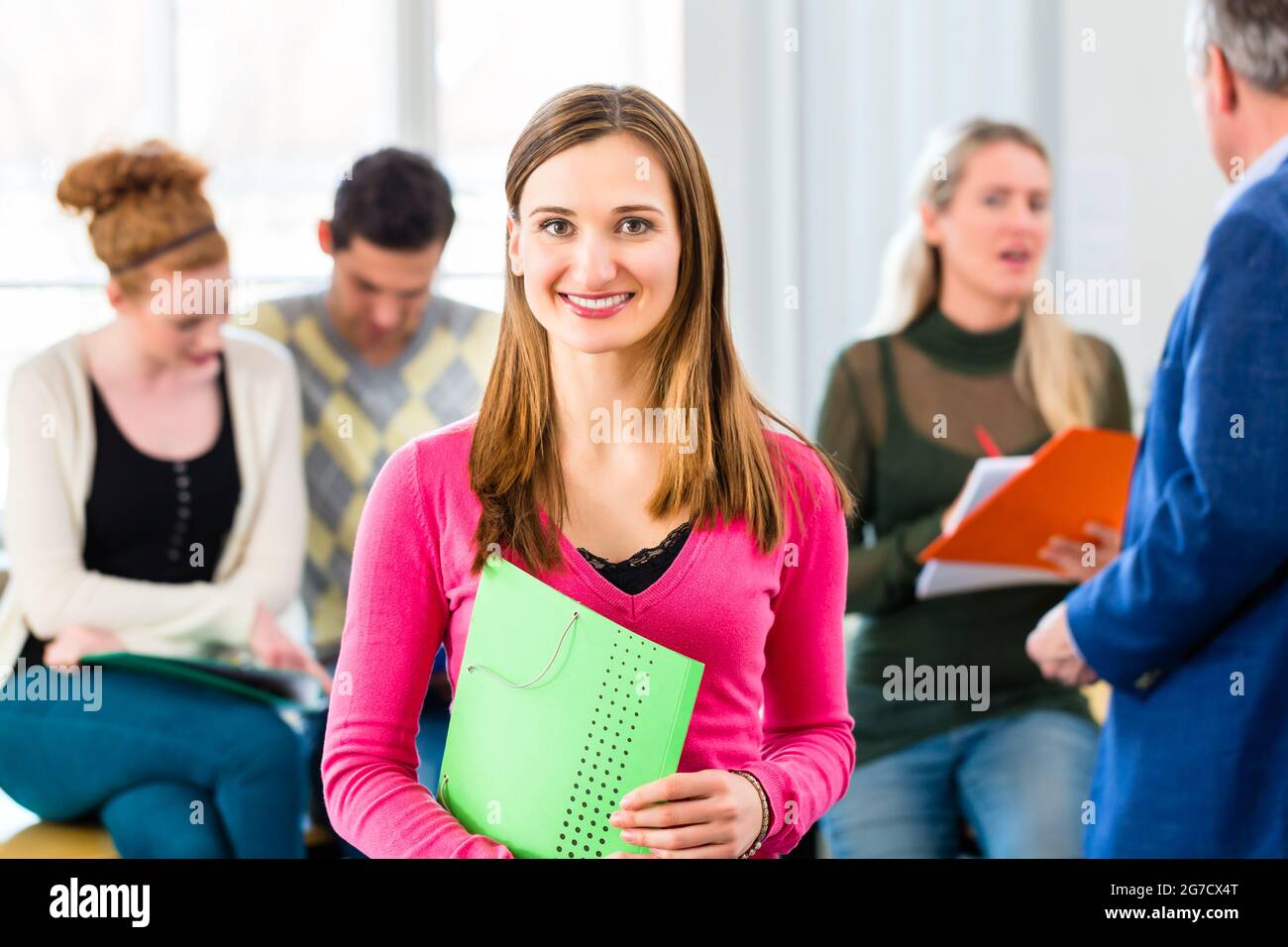 University college student standing in class room with professor Stock ...
