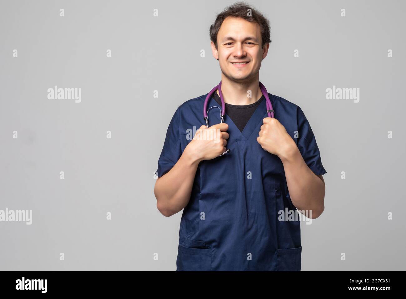 Happy doctor smiling at camera on white background Stock Photo - Alamy
