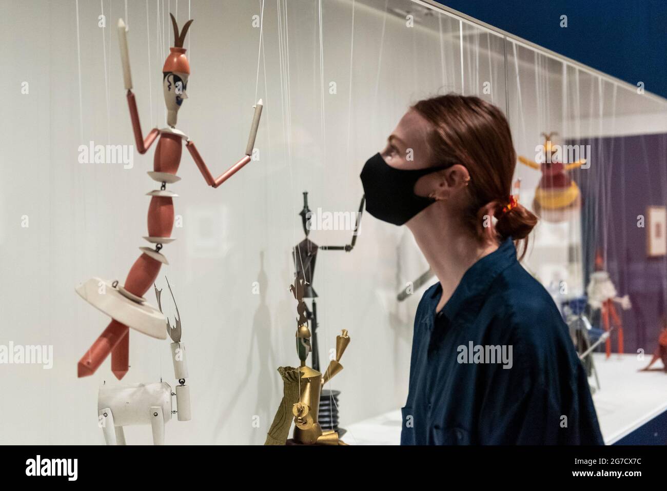 London, UK. 13 July 2021. A staff member views some of the 17 string ...