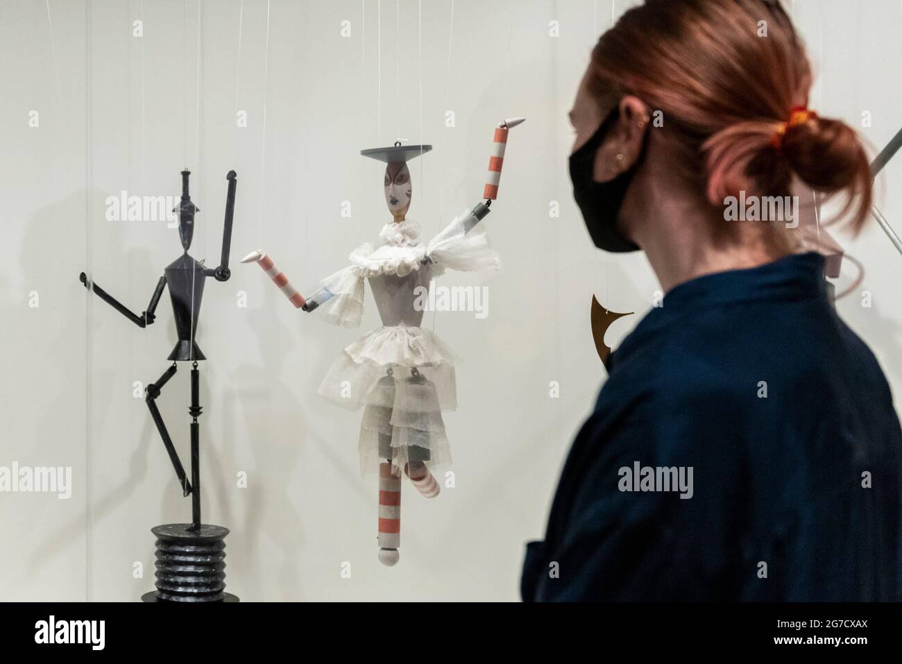 London, UK. 13 July 2021. A staff member views some of the 17 string ...