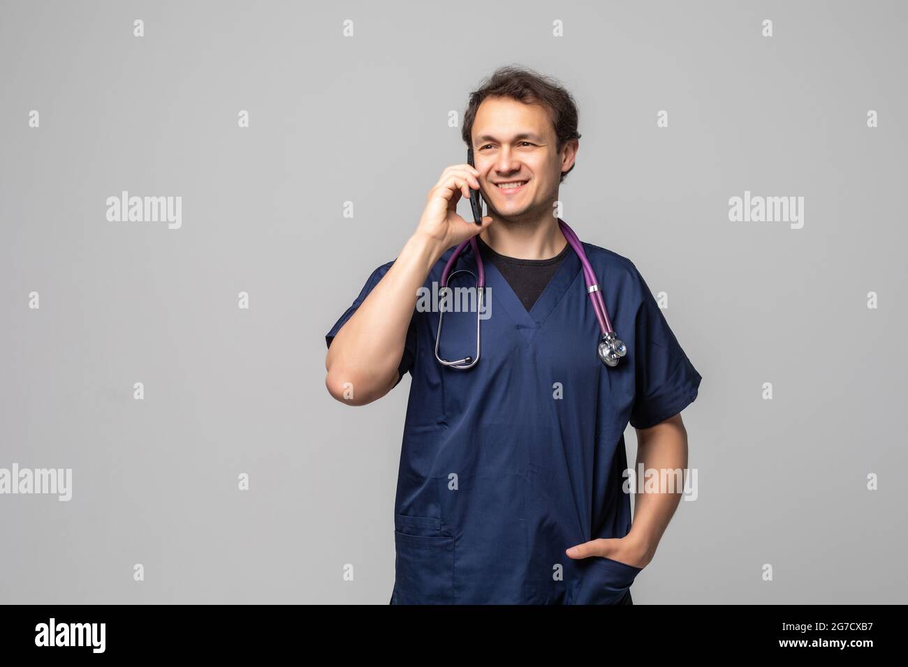Portrait of successful doctor talking on phone. Smiling medical doctor ...