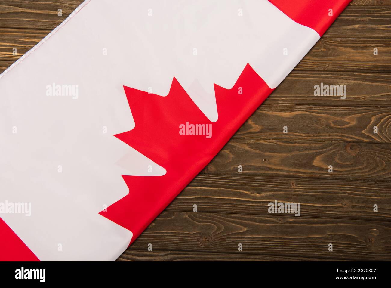 top view of canadian flag with maple leaf on wooden surface Stock Photo ...