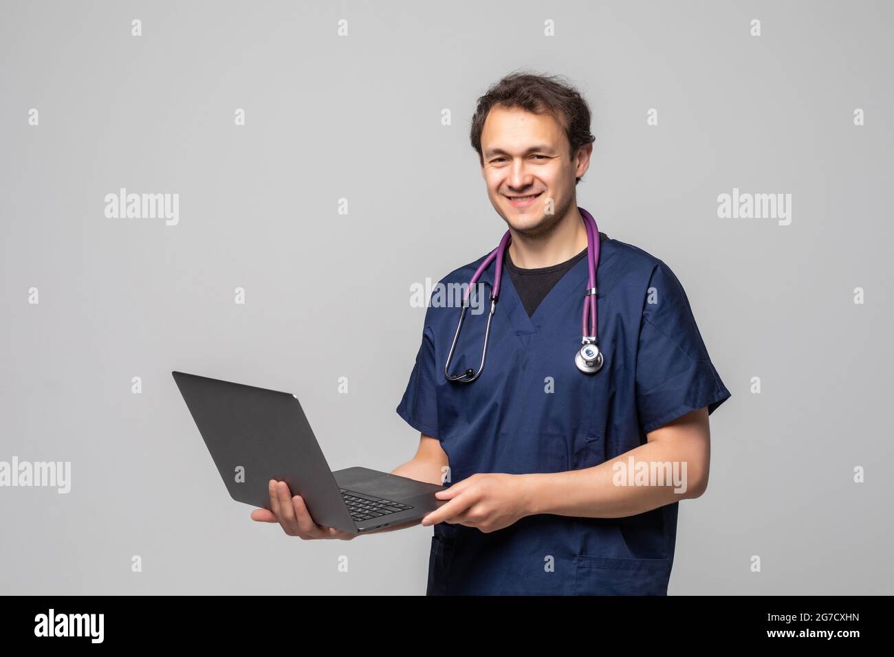 Happy Doctor using laptop over white background Stock Photo - Alamy