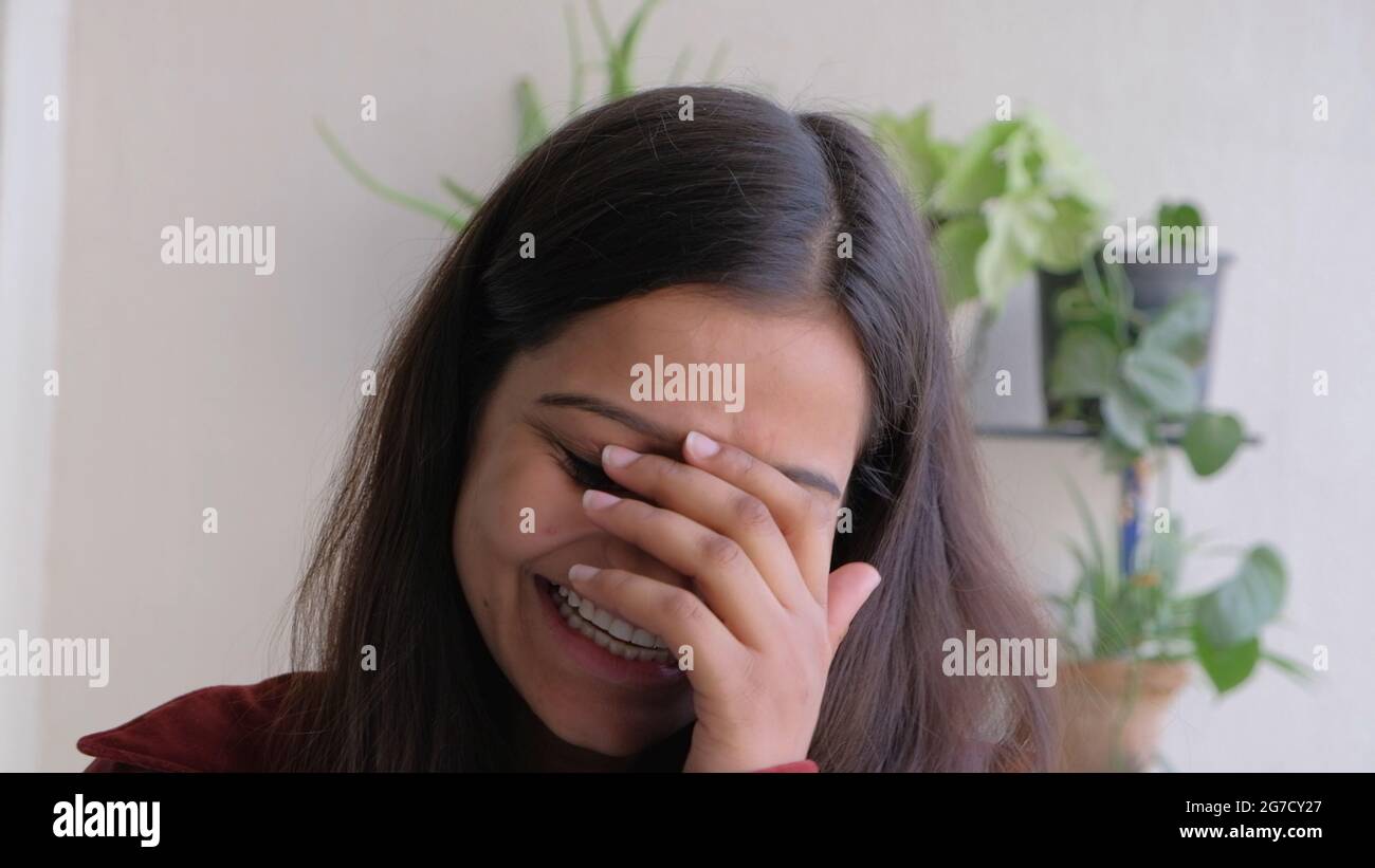 Shallow focus of a laughing Indian woman indoors Stock Photo - Alamy