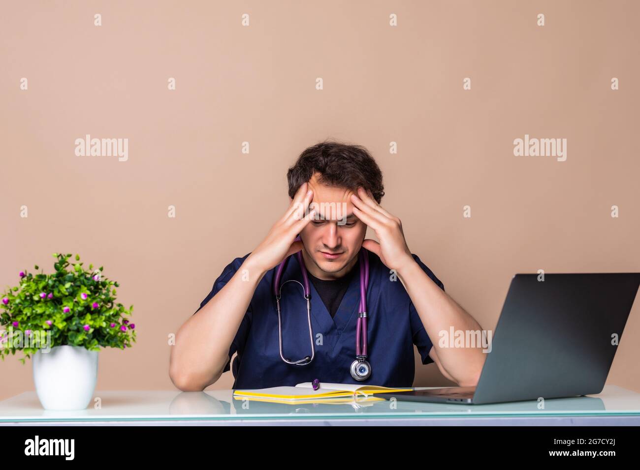 Overworked doctor sitting in his office Stock Photo - Alamy
