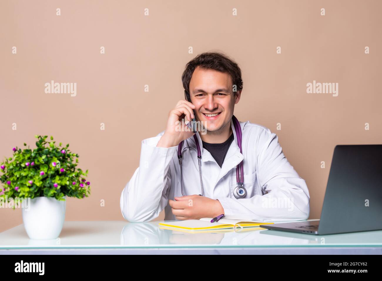 Smart and busy medic or doctor multitasking with phone on white ...