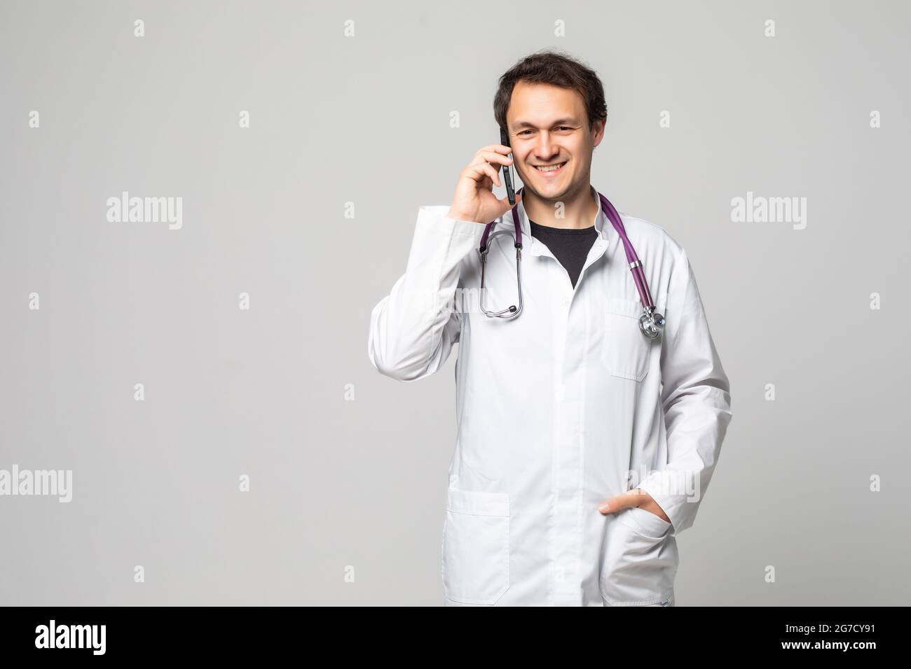 Portrait of successful doctor talking on phone. Smiling medical doctor ...