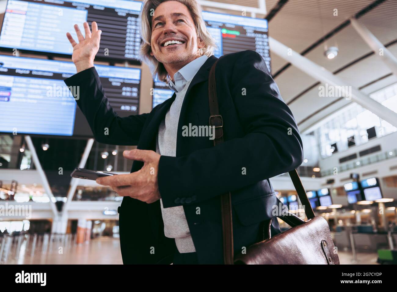Businessman waving away while at international airport. Business ...