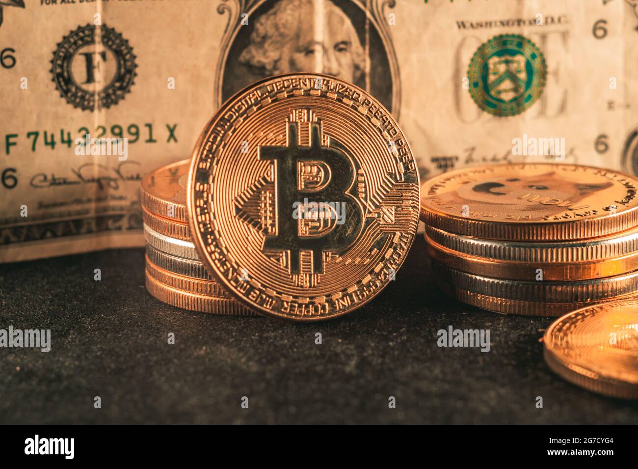 Pile of gold bitcoin cryptocurrency and one-dollar bill Stock Photo - Alamy
