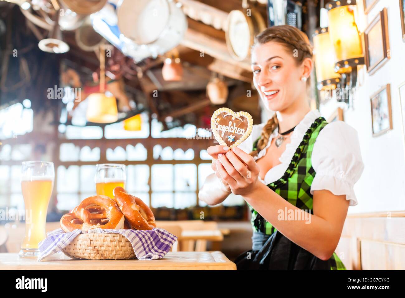 Bavarian woman wearing dirndl got gingerbread heart in german beer ...