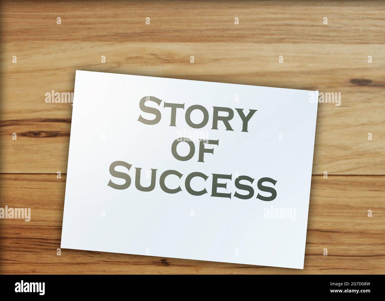 Success story typed on page and paper dollar signs around on wooden ...
