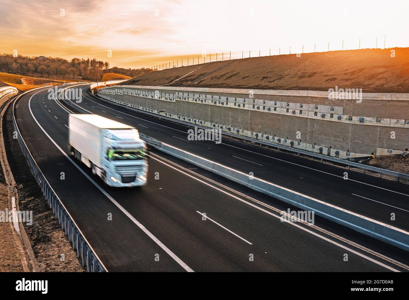 Fast moving blurry truck on the highway at sunset. European highway ...