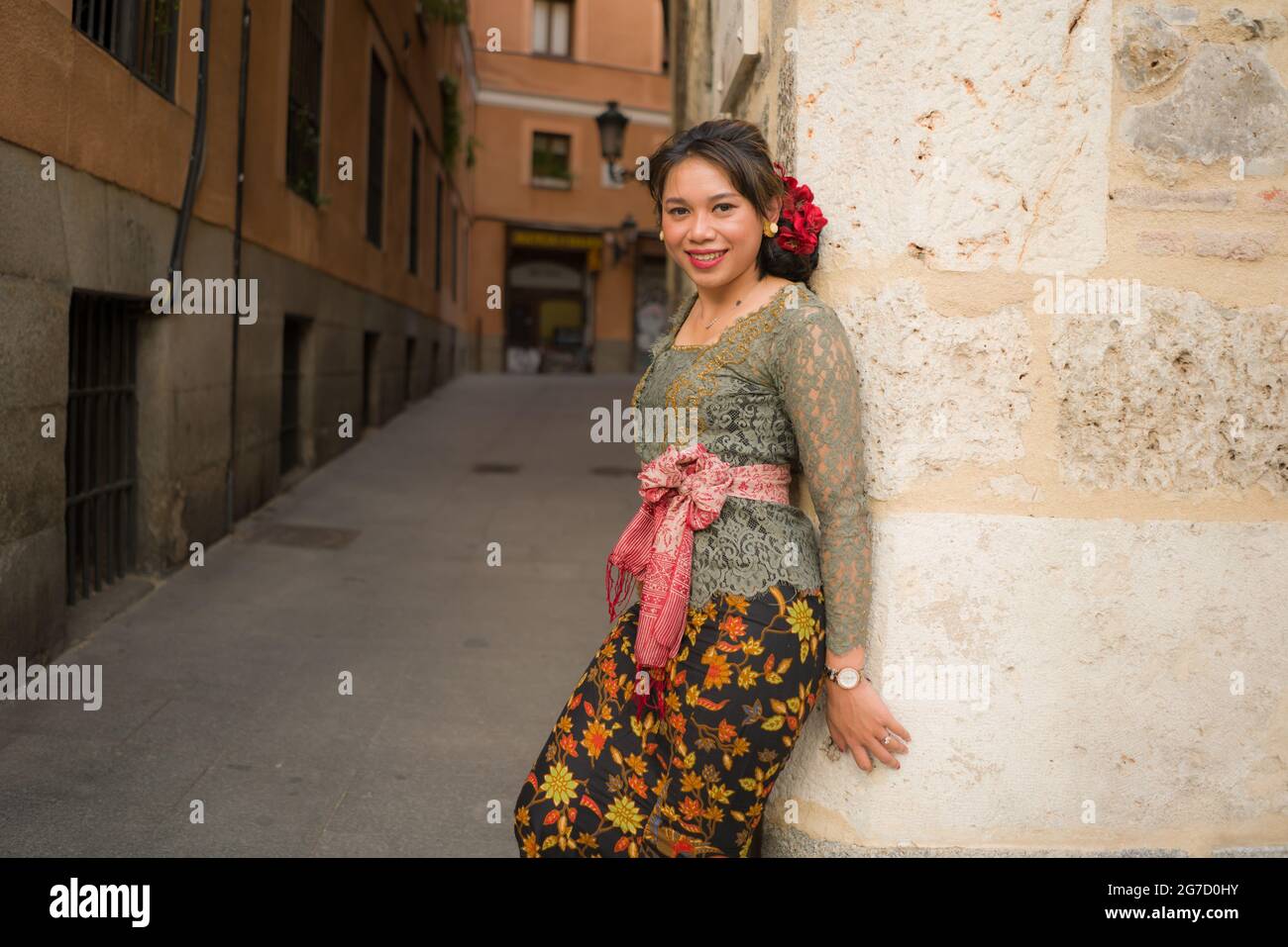 young happy and beautiful Asian woman wearing traditional Balinese ...