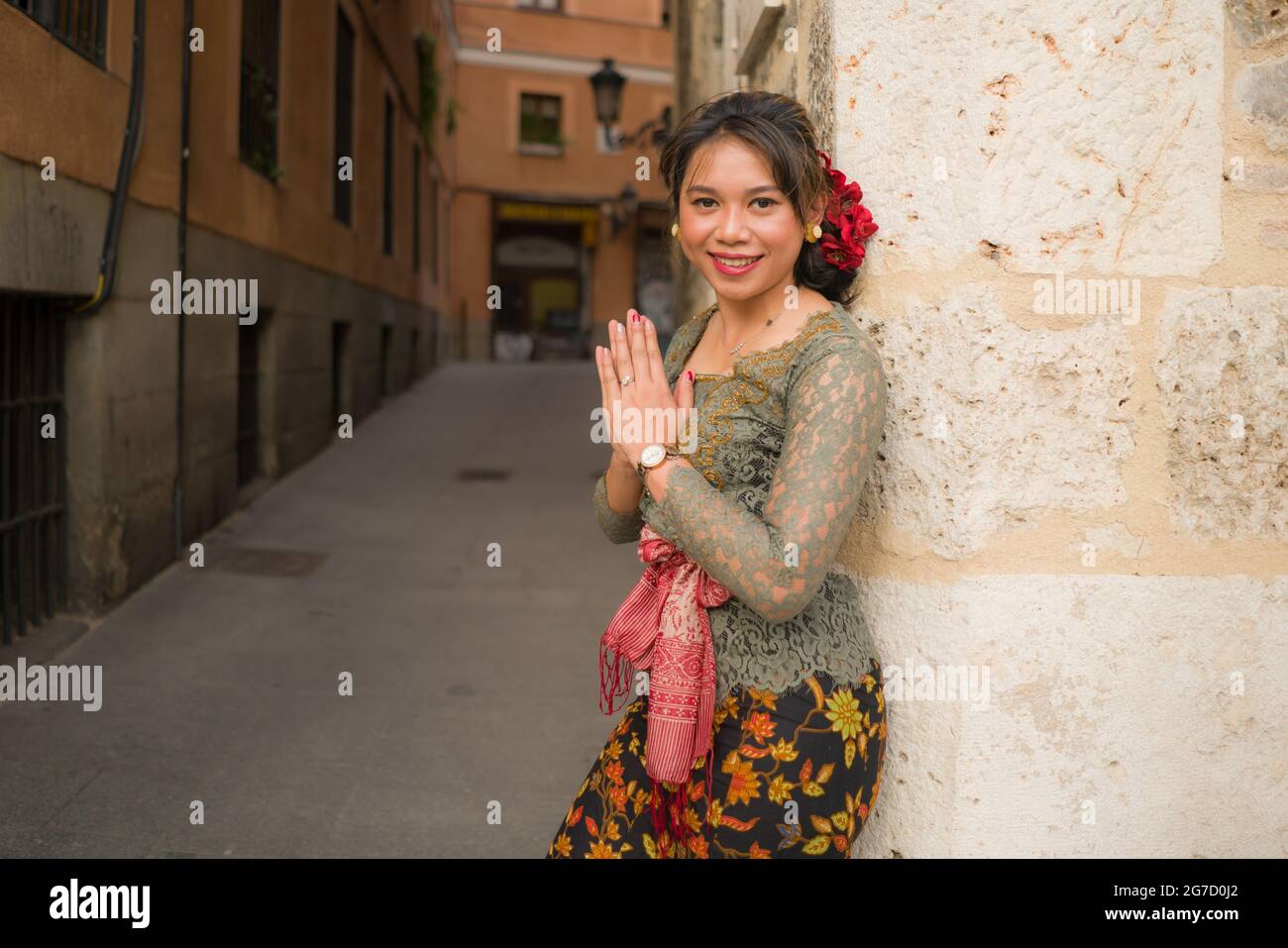 young happy and beautiful Asian woman wearing traditional Balinese ...
