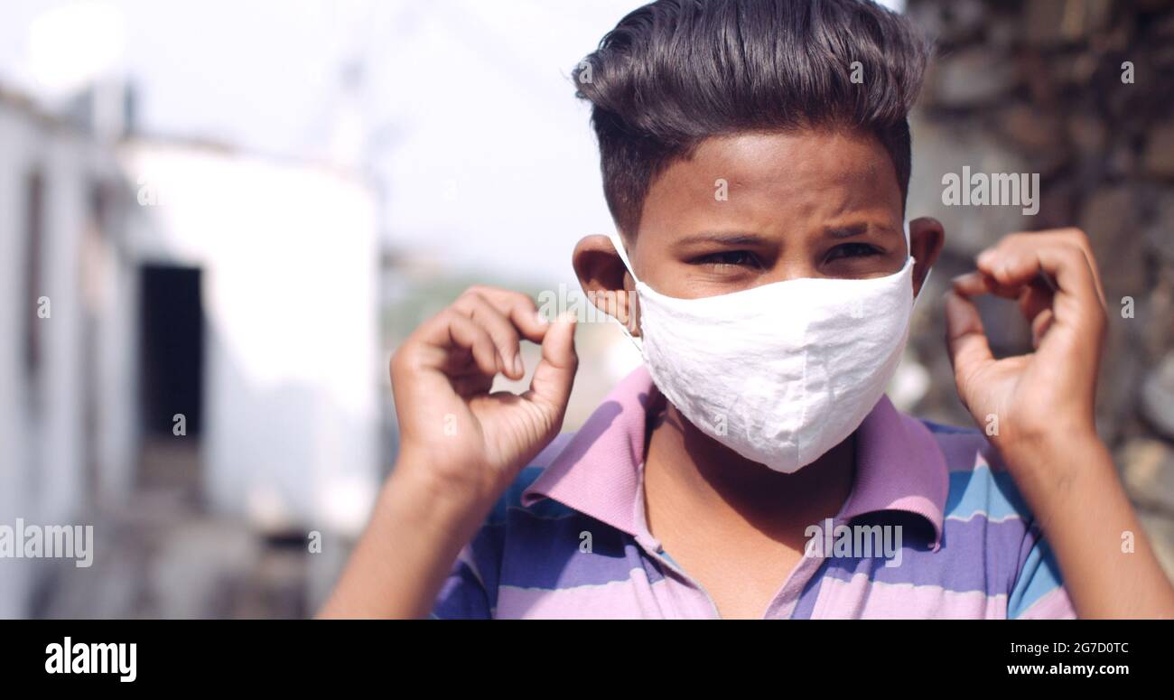 Closeup shot of an Indian boy wearing a mask- new normal concept Stock ...
