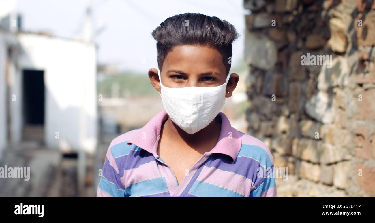Closeup shot of an Indian boy wearing a mask- new normal concept Stock ...