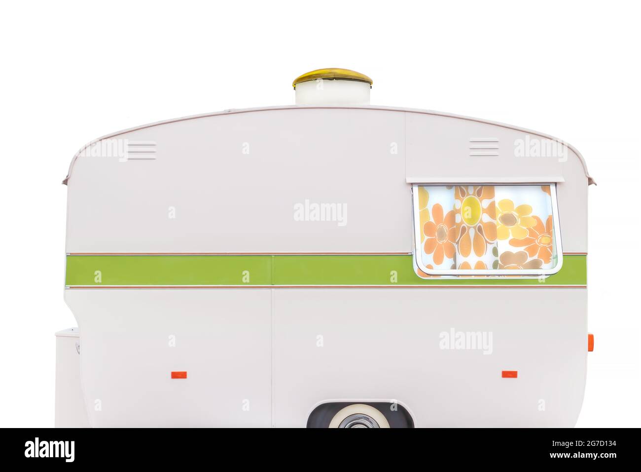 Side view of a vintage caravan with flower curtain isolated on a white ...