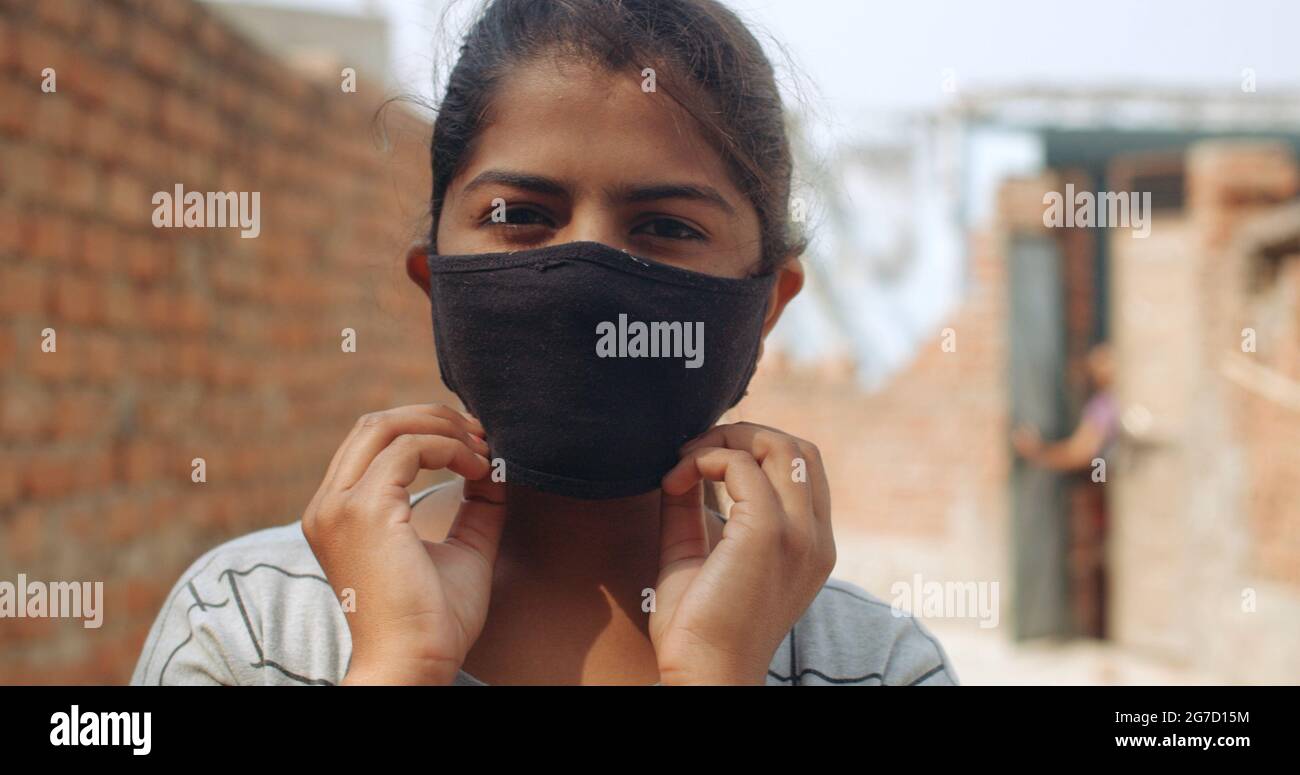 Closeup shot of an Indian girl wearing a mask- new normal concept Stock Photo - Alamy