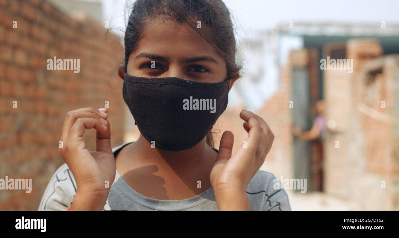 Closeup shot of an Indian girl wearing a mask- new normal concept Stock ...