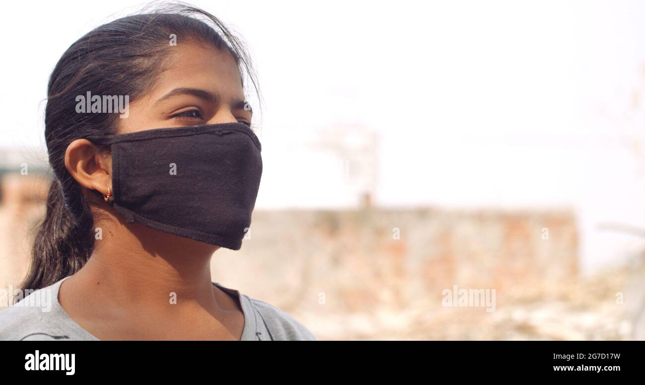 Closeup shot of an Indian girl wearing a mask- new normal concept Stock Photo - Alamy