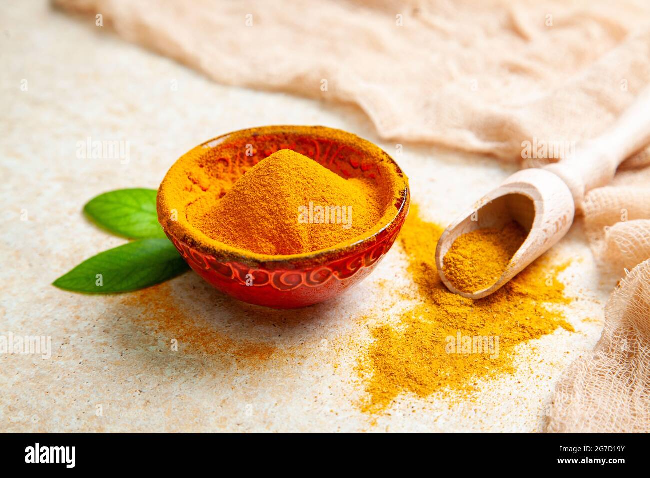 Dried turmeric powder with leaves on a light background Stock Photo - Alamy