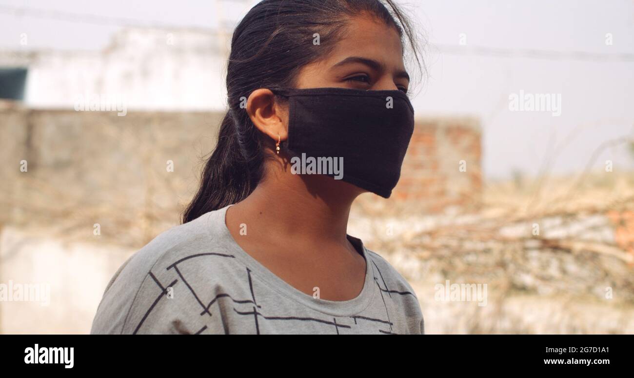 Closeup shot of an Indian girl wearing a mask- new normal concept Stock Photo - Alamy
