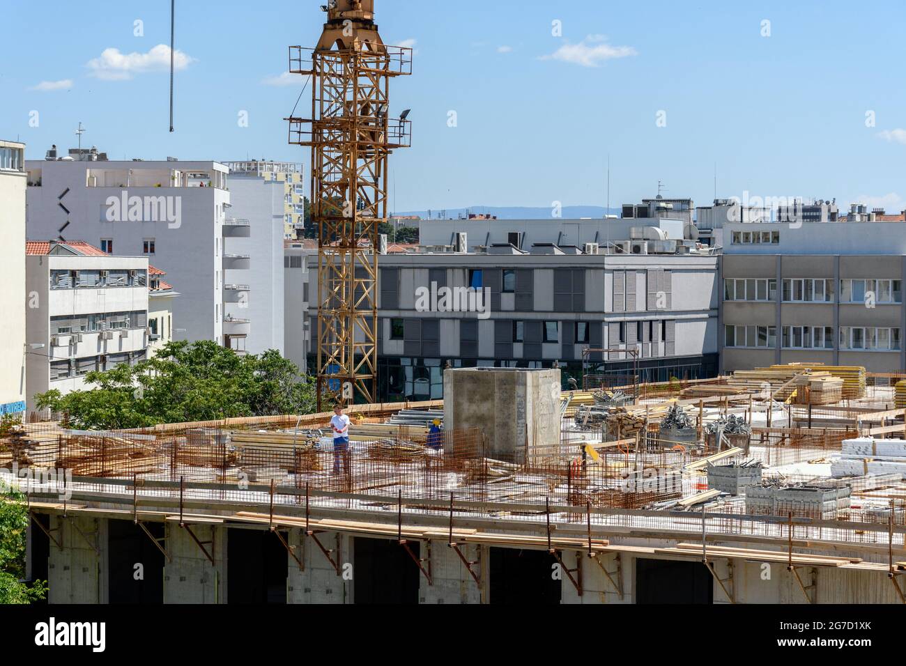 Construction worker at work on construction site of building in city ...