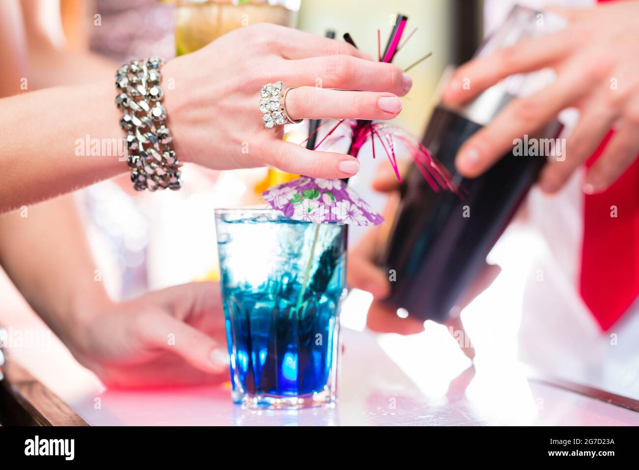 Friends drinking with barkeeper cocktails in fancy night club Stock ...