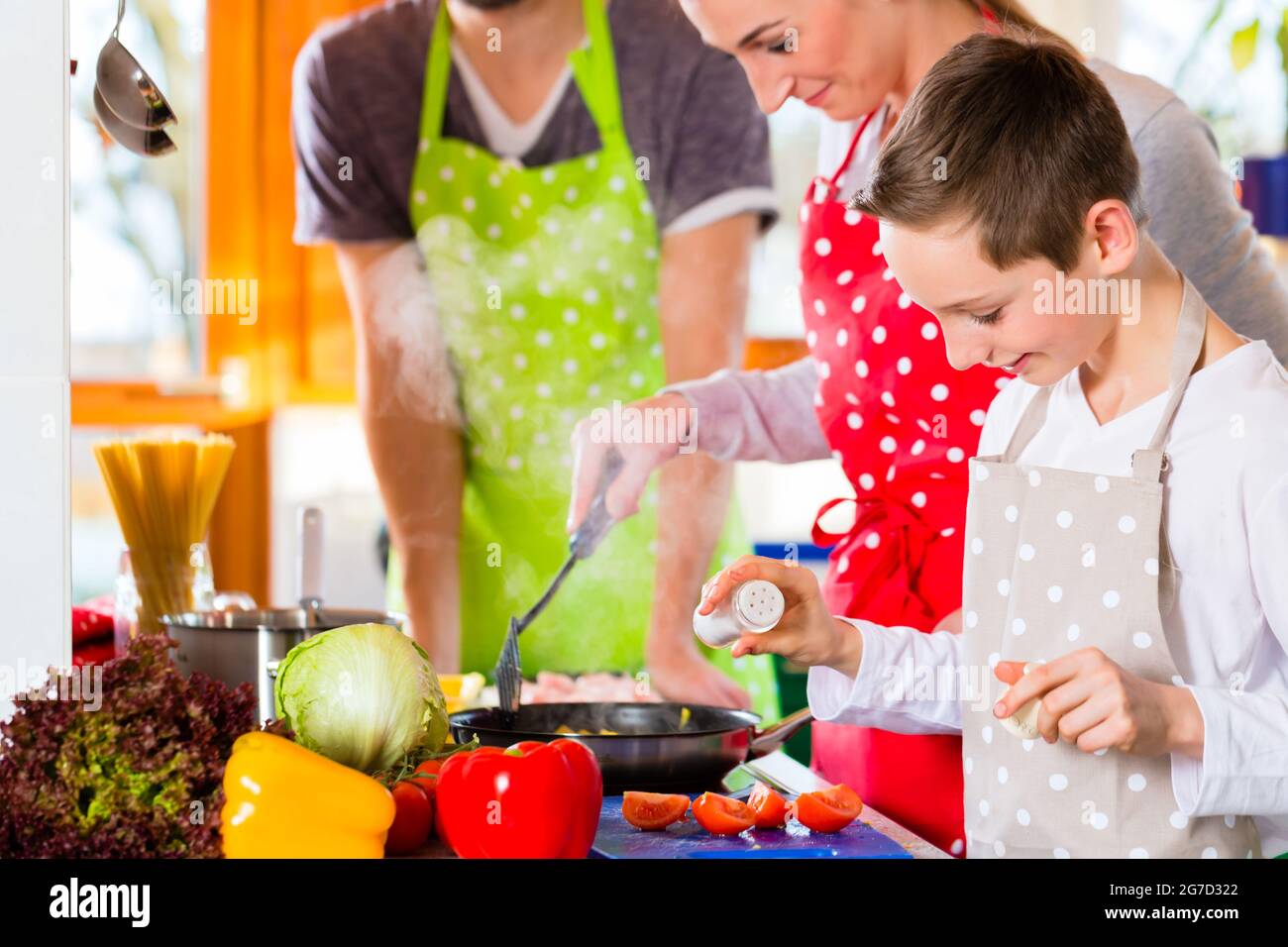 Family with Parents and children preparing healthy meal in domestic ...