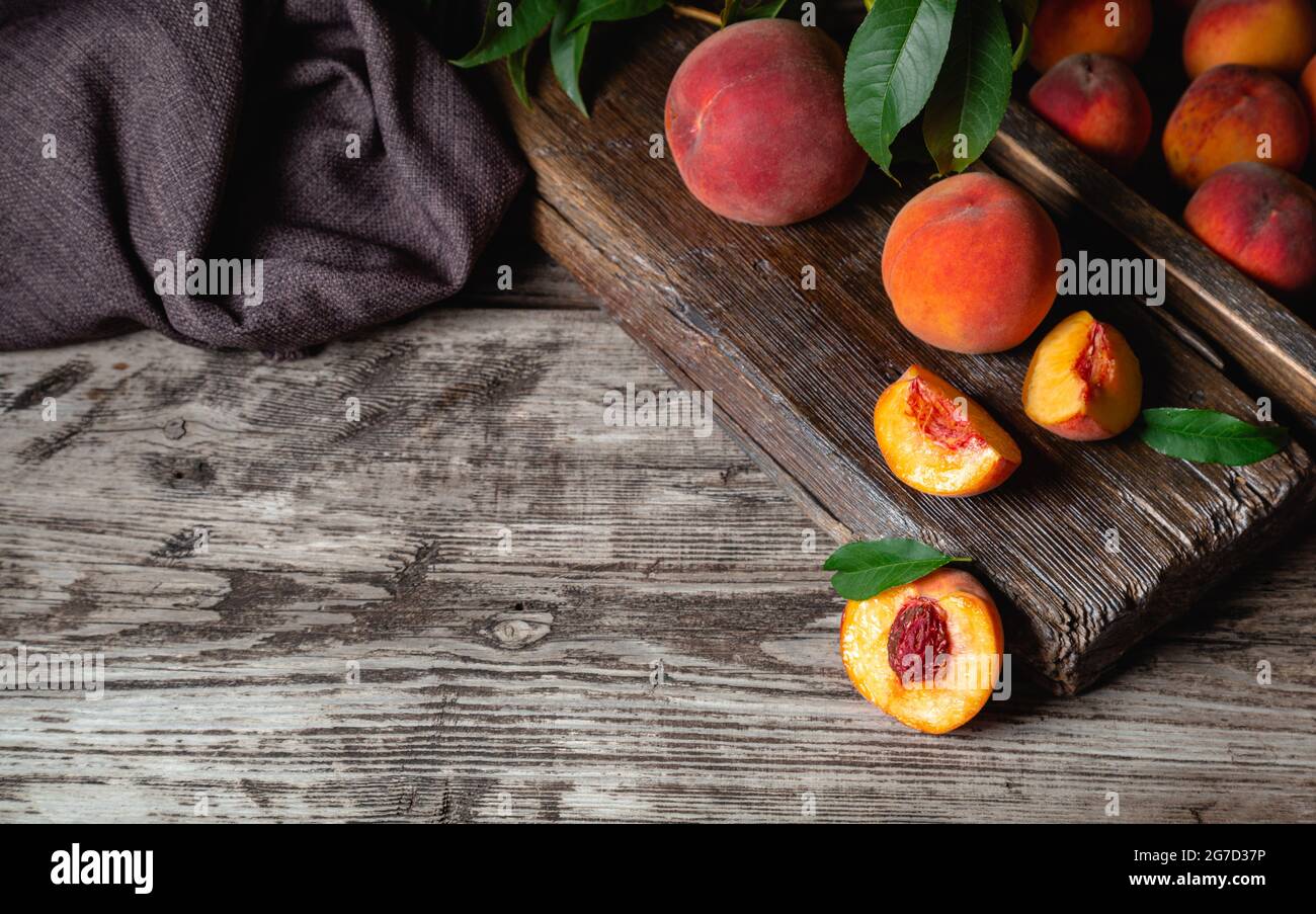 Juicy ripe peaches on dark wooden rustic table with copy space ...