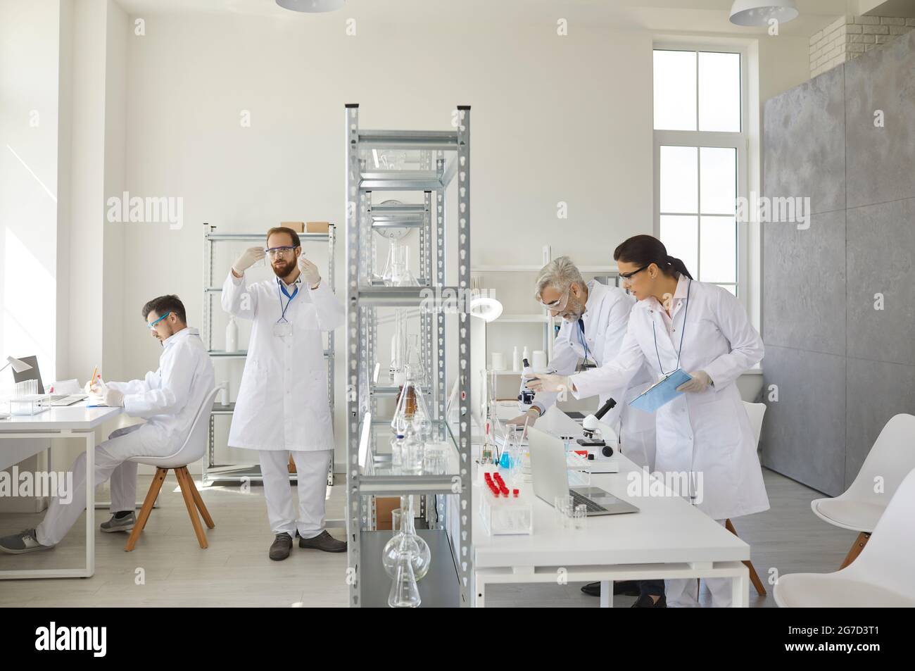 Medical research scientists working at laboratory using advanced ...